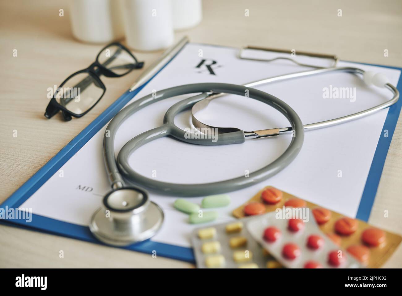 Stethoscope and medicine on prescription document on doctors table ...