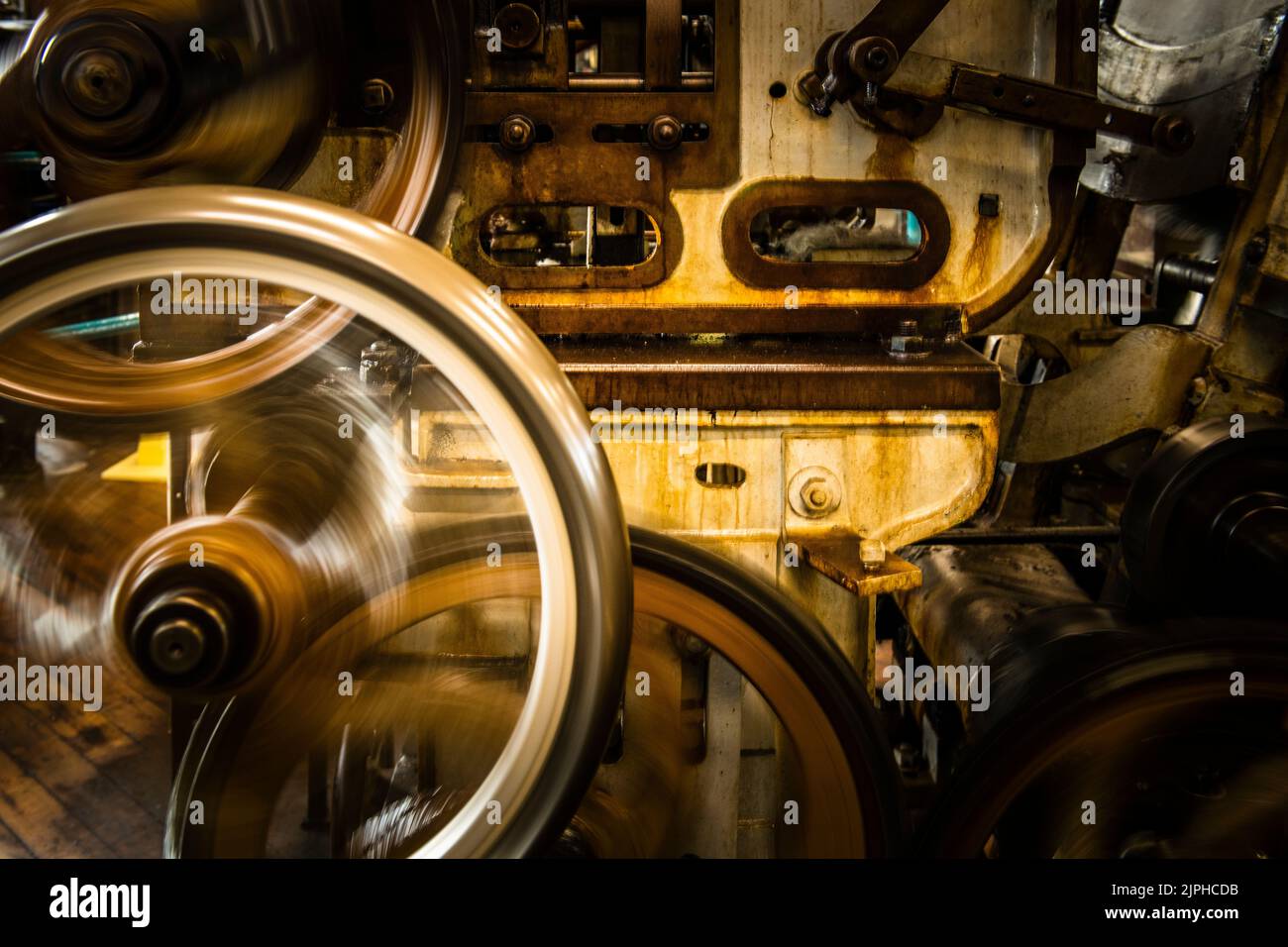 Spinning wheels on an old machine Stock Photo - Alamy