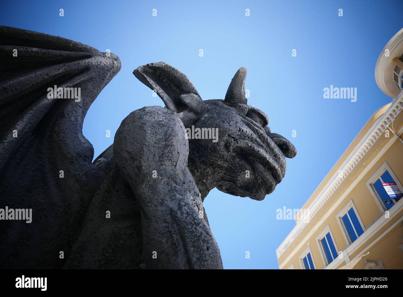 Statue of a gargoyle in the city Stock Photo - Alamy