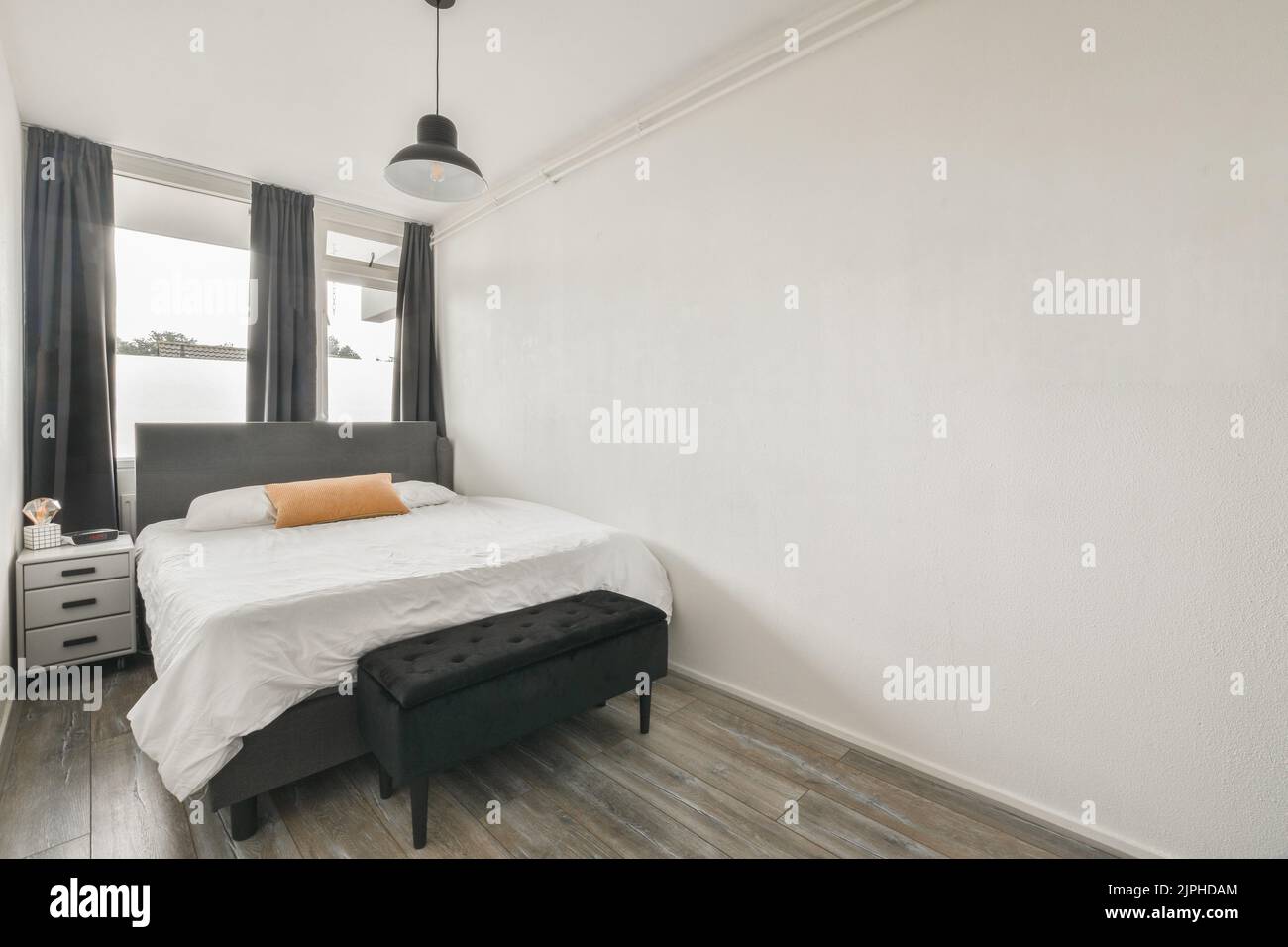 Comfortable bed placed near green wall in modern minimalist style ...