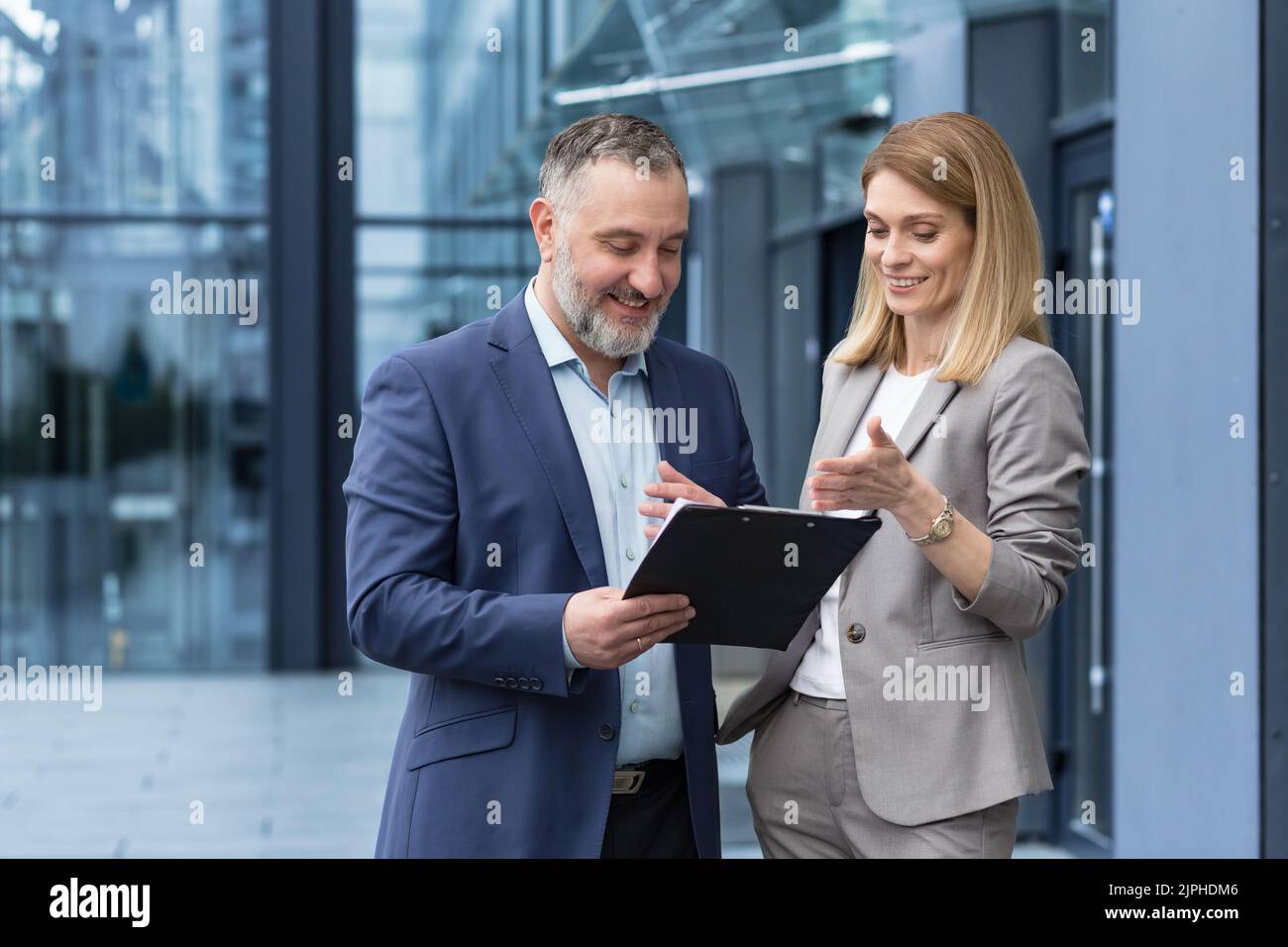 Two business colleagues man and woman talking and discussing work ...