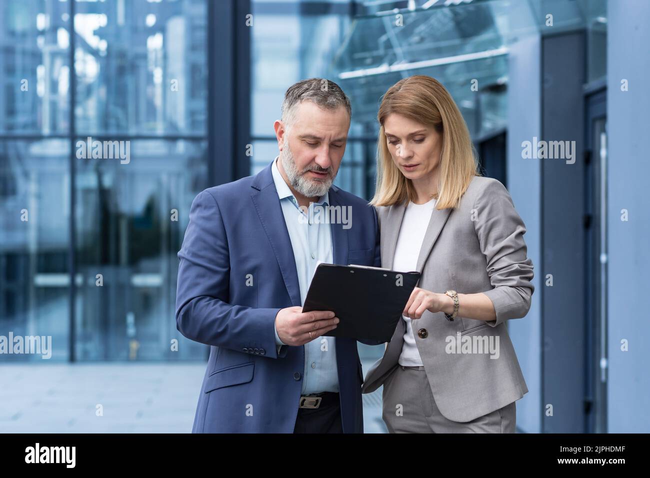 Two colleagues are concentrating and thinking, a man and a woman in ...