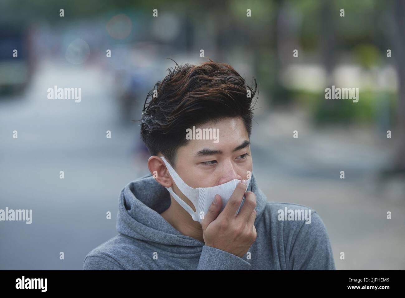 Asian man wearing face man covering hi-res stock photography and images ...