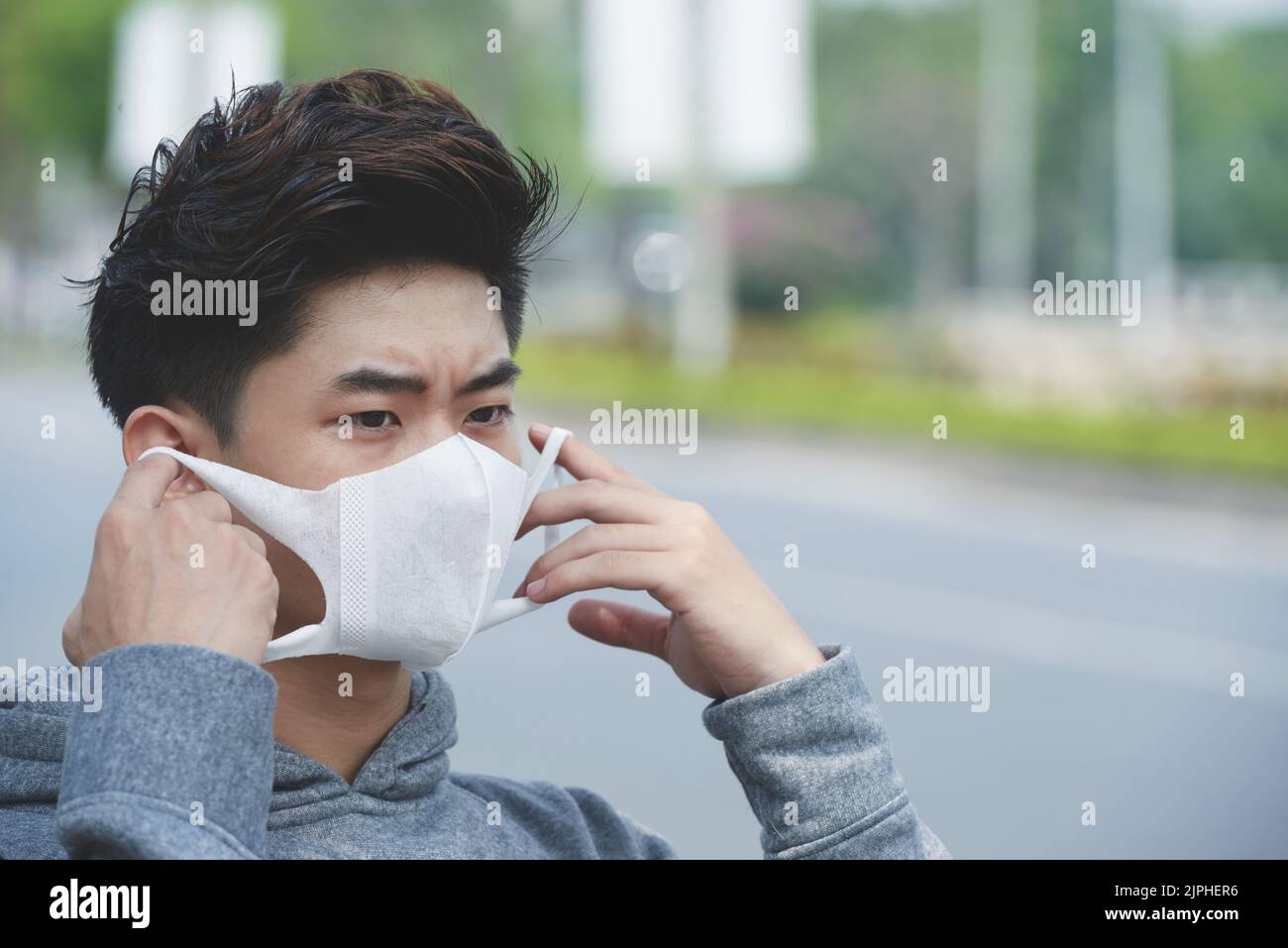 Asian man wearing face man covering hi-res stock photography and images ...