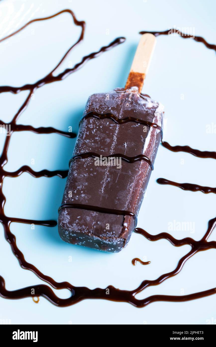 creamy ice cream in milk chocolate on a plate, cold frozen ice cream on ...