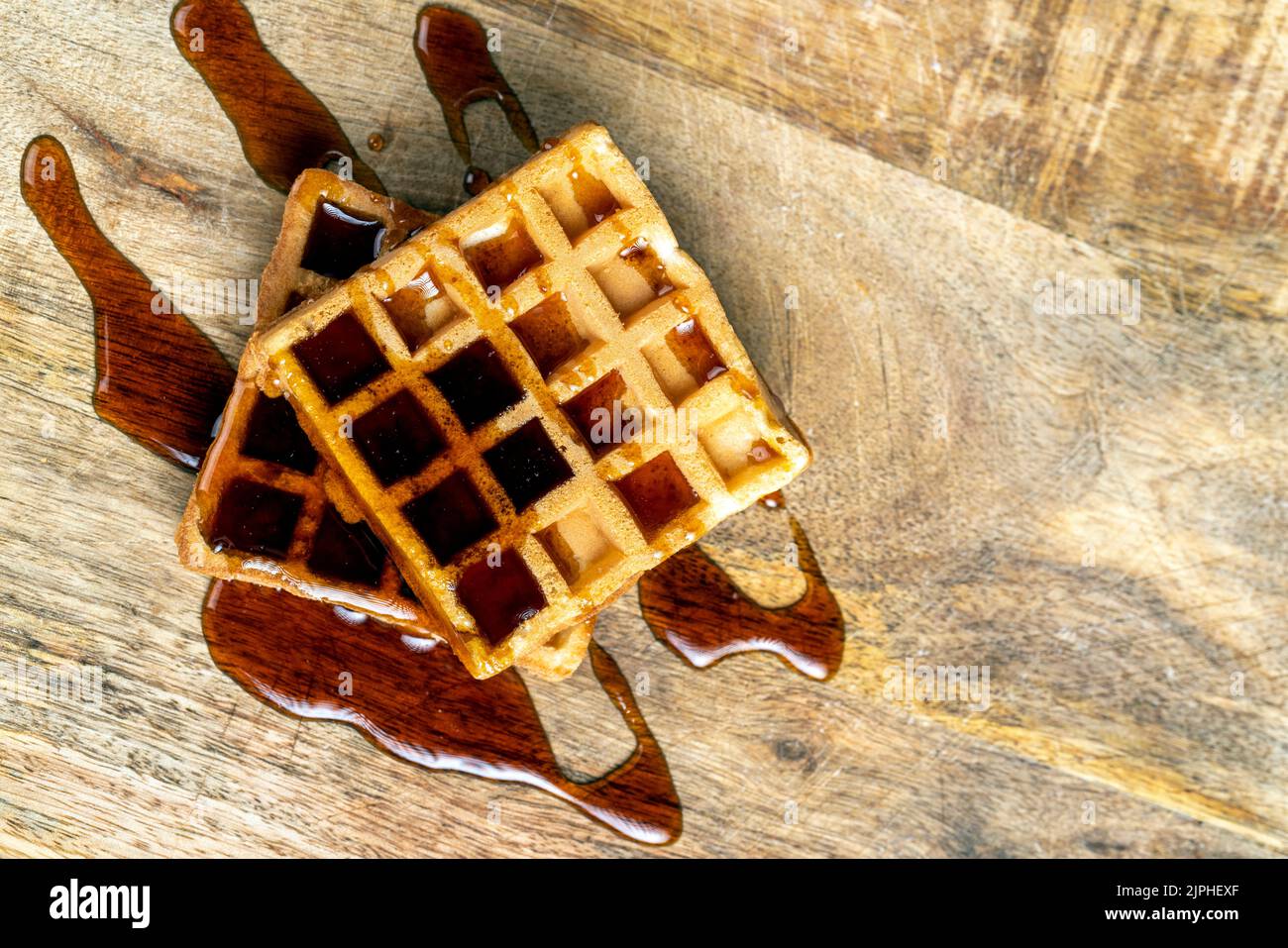 square sweet soft waffles in bee honey , a traditional European dessert ...