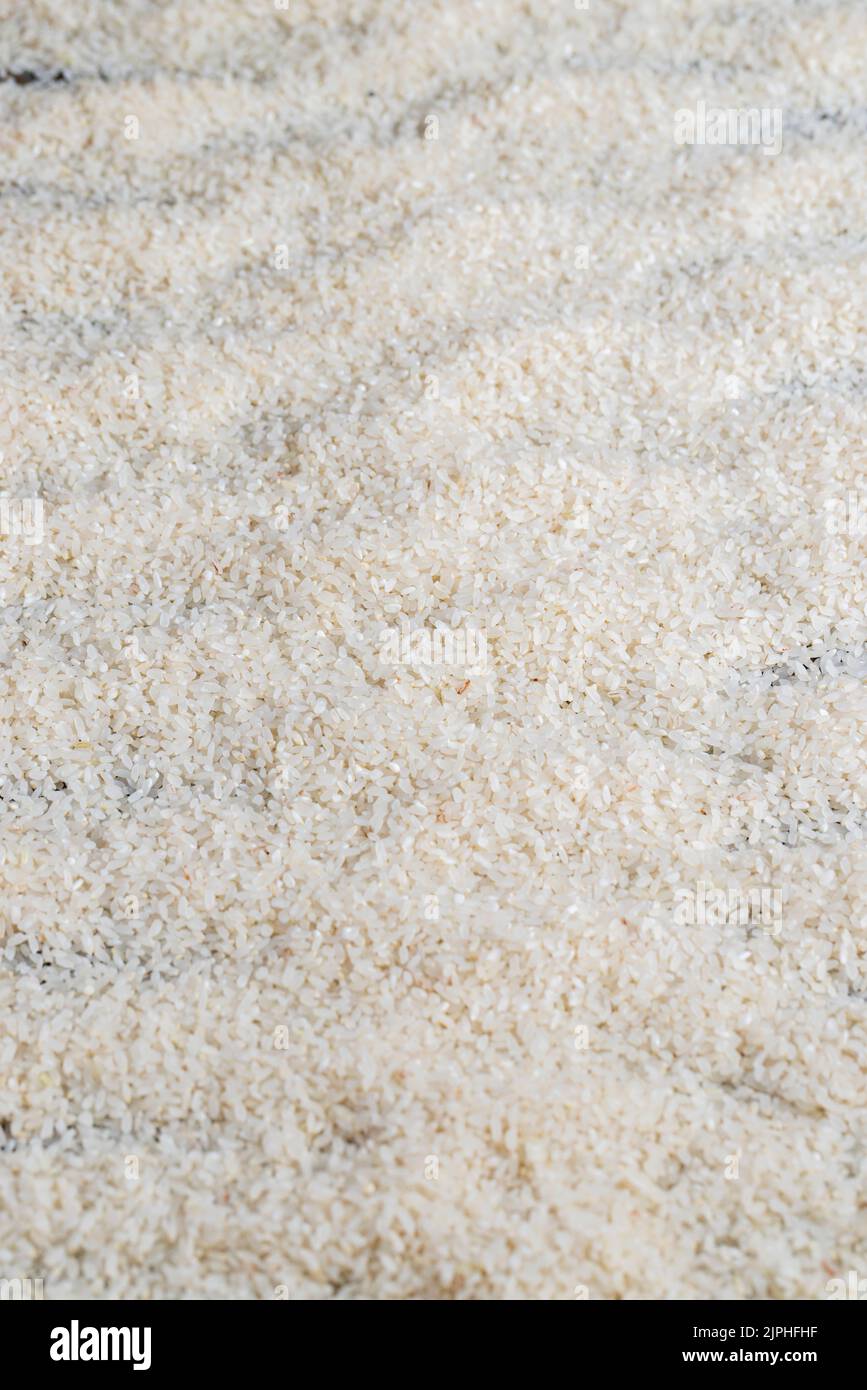 a pile of scattered white rice on the kitchen table, white uncooked ...