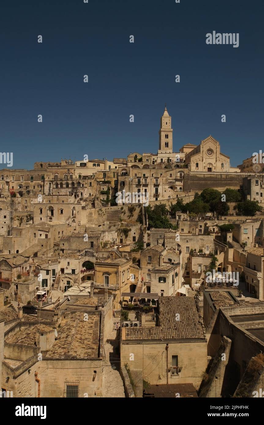 View at old buildings, walls, roofs and rock with religious cross in ...