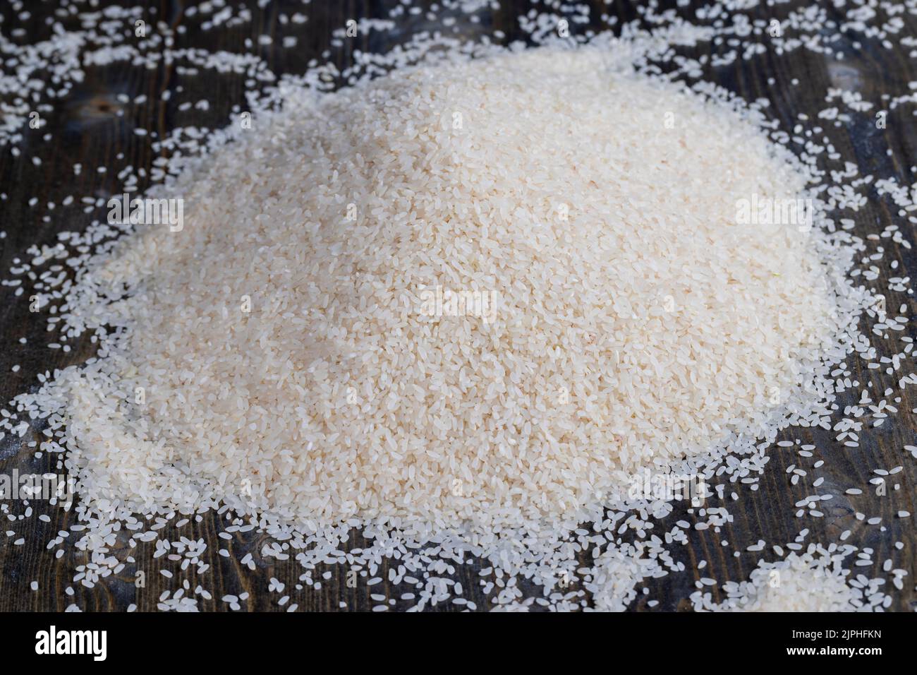 a pile of scattered white rice on the kitchen table, white uncooked ...