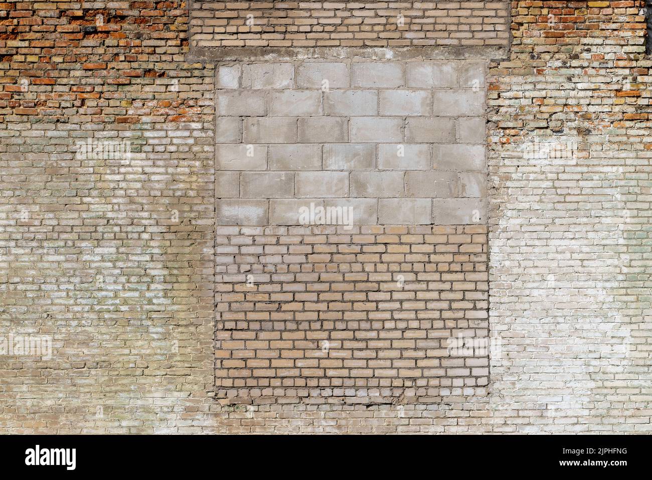an old brick wall made of a large number of different types of bricks ...
