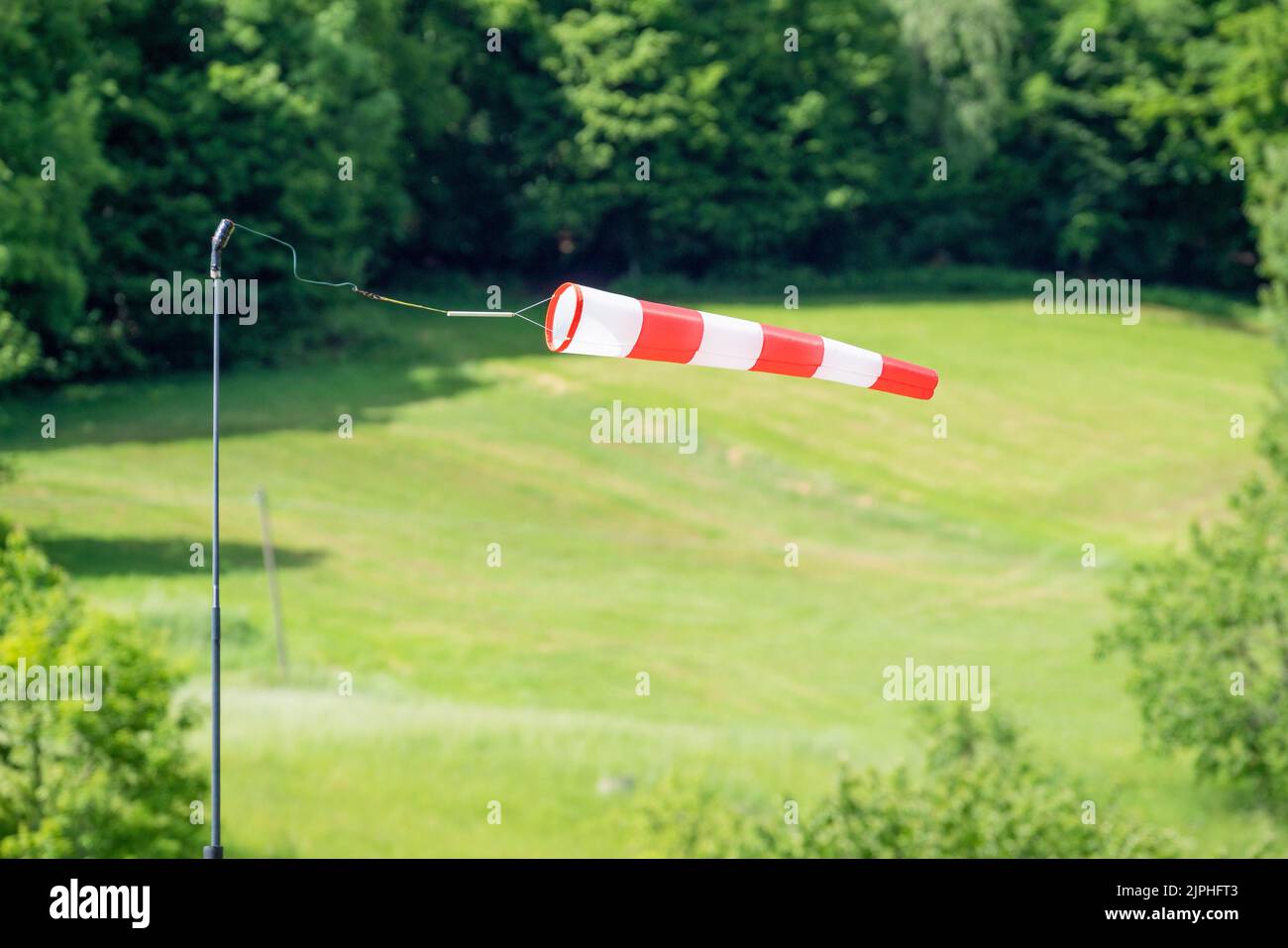 A beautiful view of a windsock in a background of green field with ...
