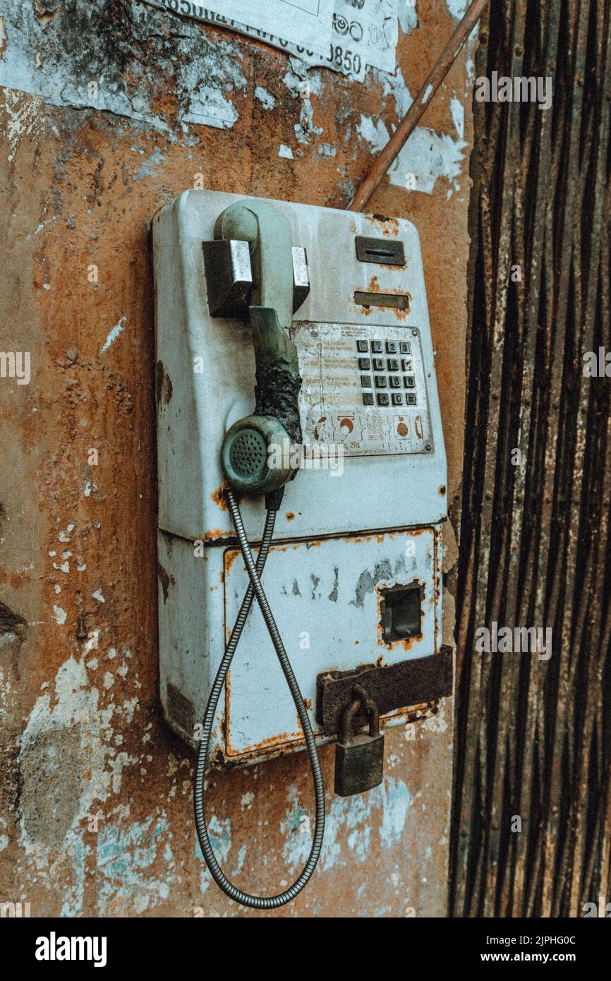 A vertical closeup of an old public phone Stock Photo - Alamy