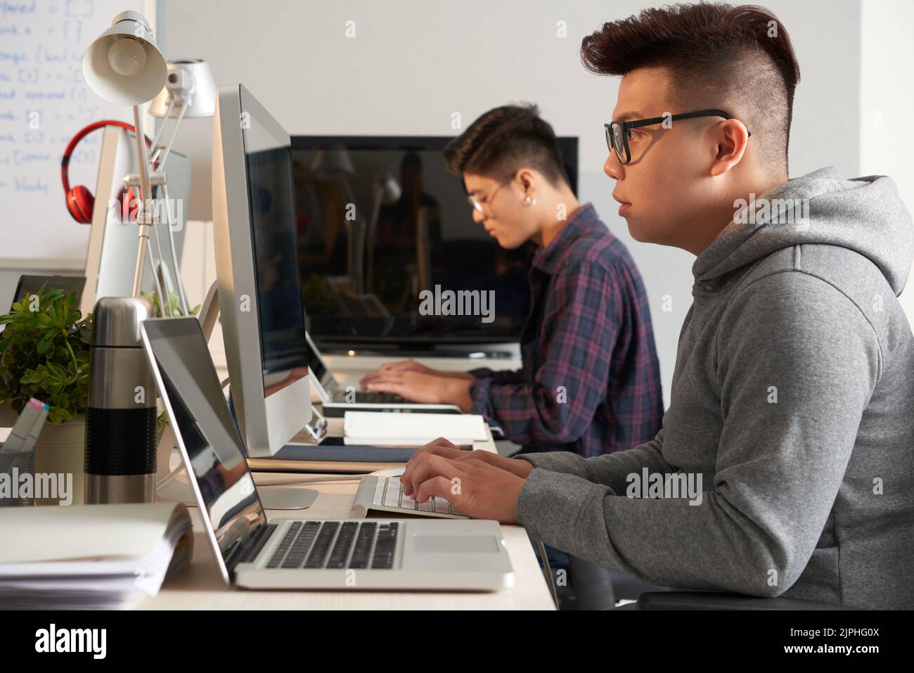 Group of talented young programmers sitting at spacious open plan ... Group of talented young programmers sitting at spacious open plan ...