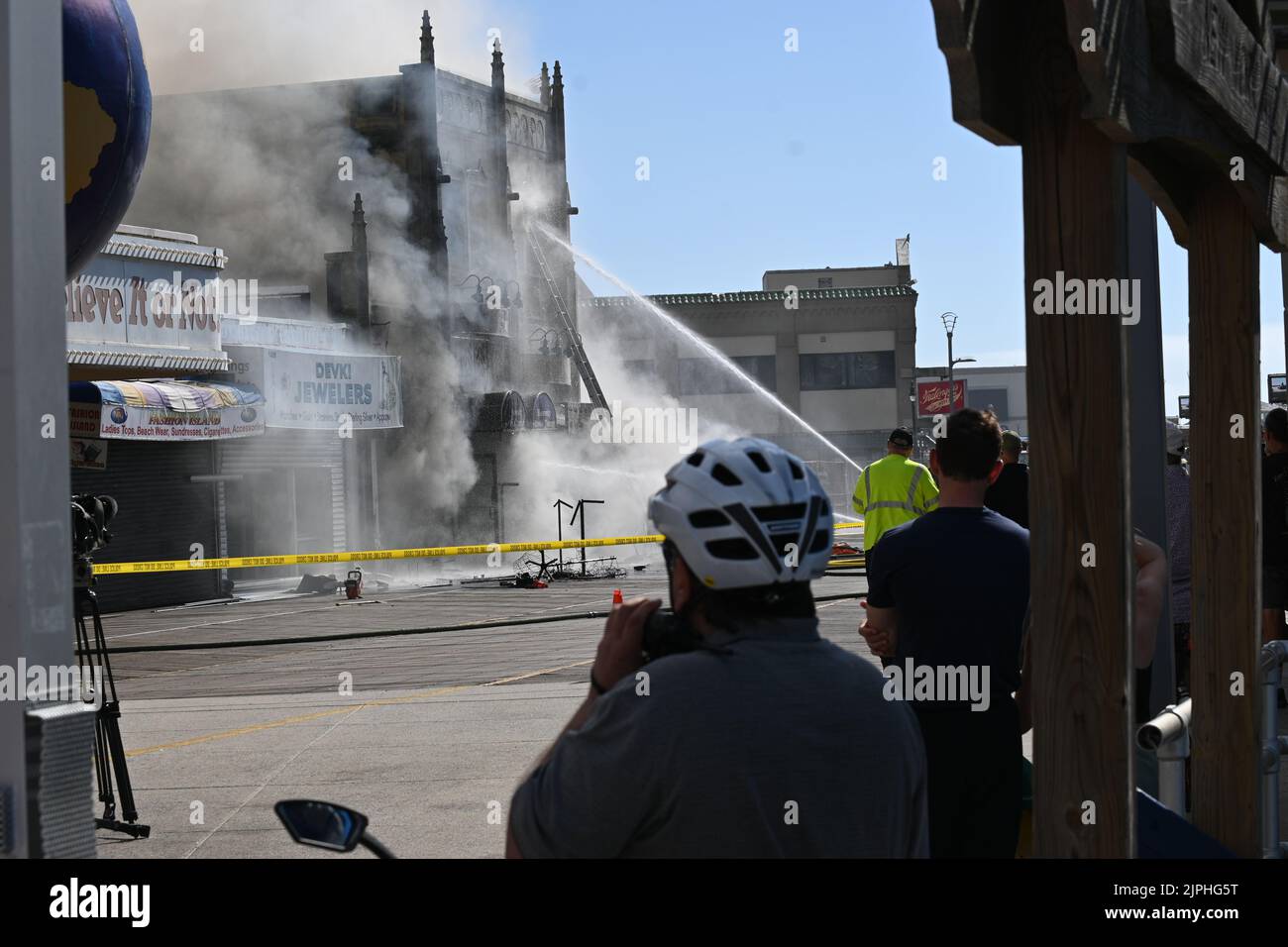 The crowd of people, firefighters, and policemen in the street during ...