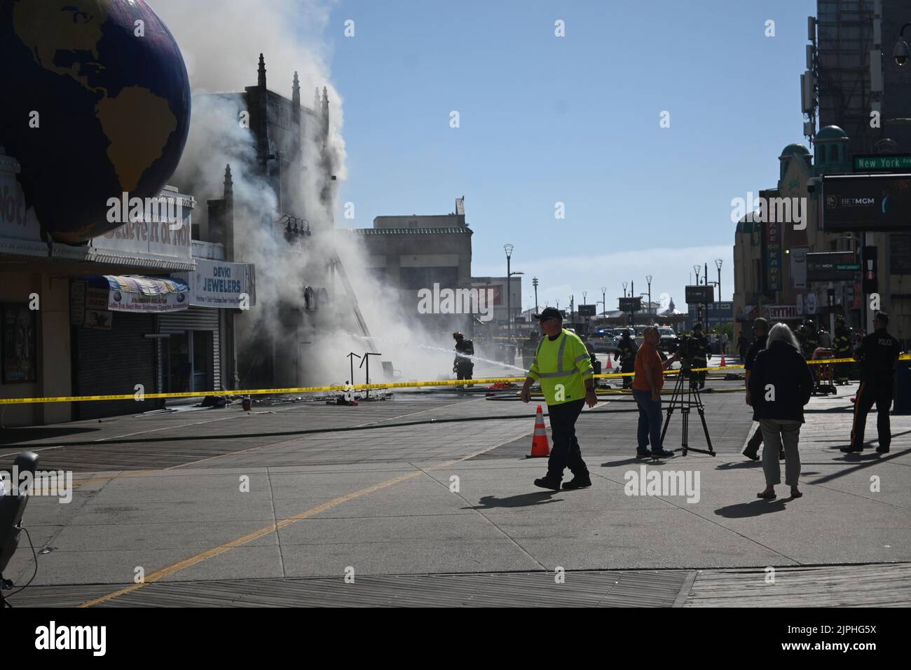The crowd of people, firefighters, and policemen in the street during ...