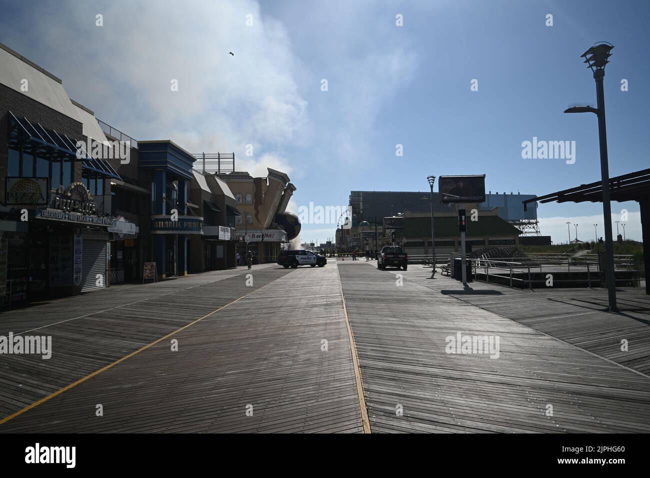 The crowd of people, firefighters, and policemen in the street during ...