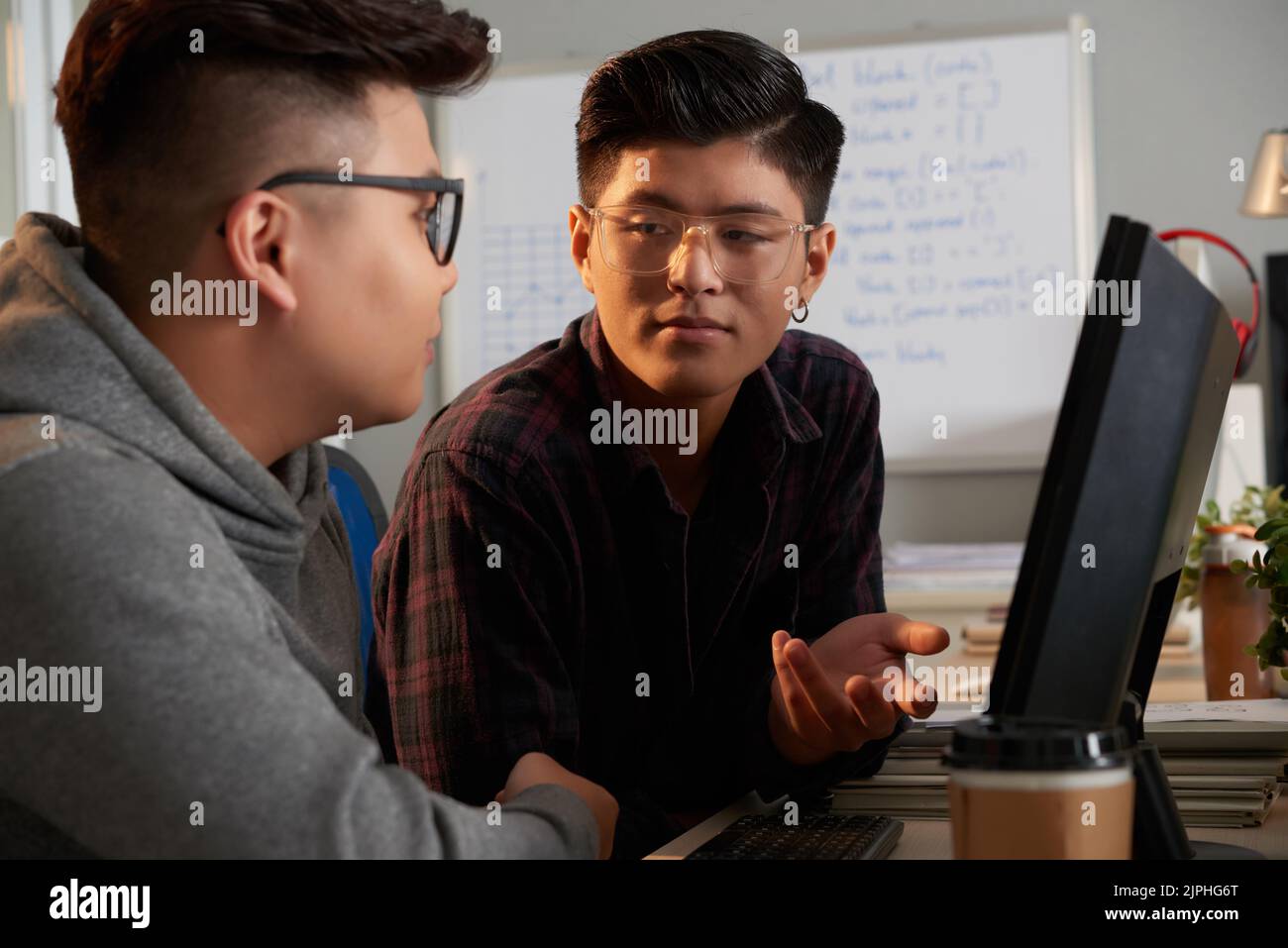 Handsome young programmers wearing eyeglasses having productive ... Handsome young programmers wearing eyeglasses having productive ...