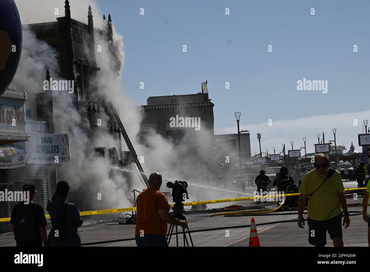 The crowd of people, firefighters, and policemen in the street during ...