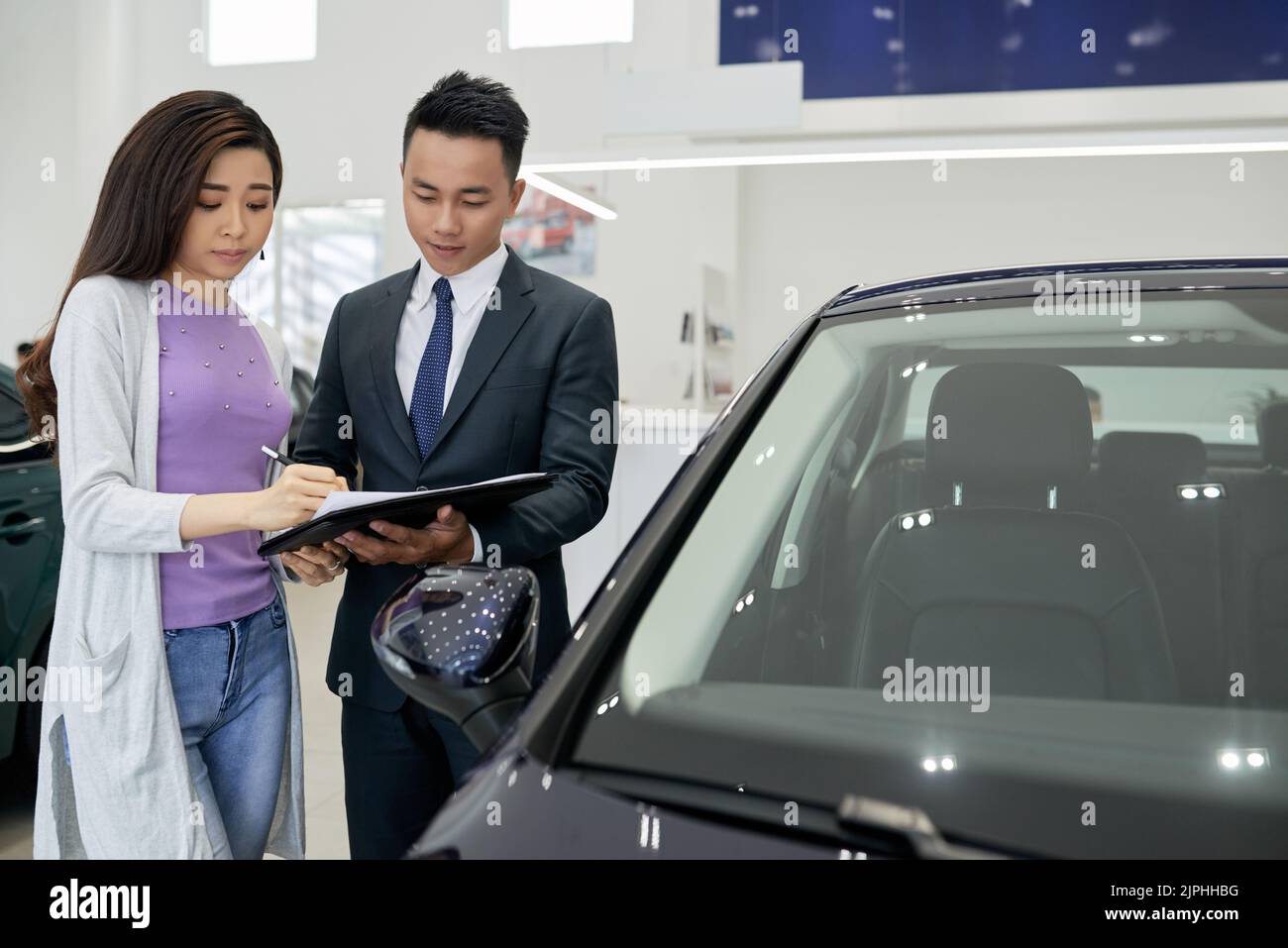 Asian female signing documents hi-res stock photography and images - Alamy