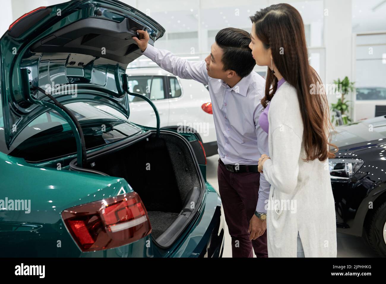 Vietnamese married couple checking trunk closing mechanism Stock Photo ...