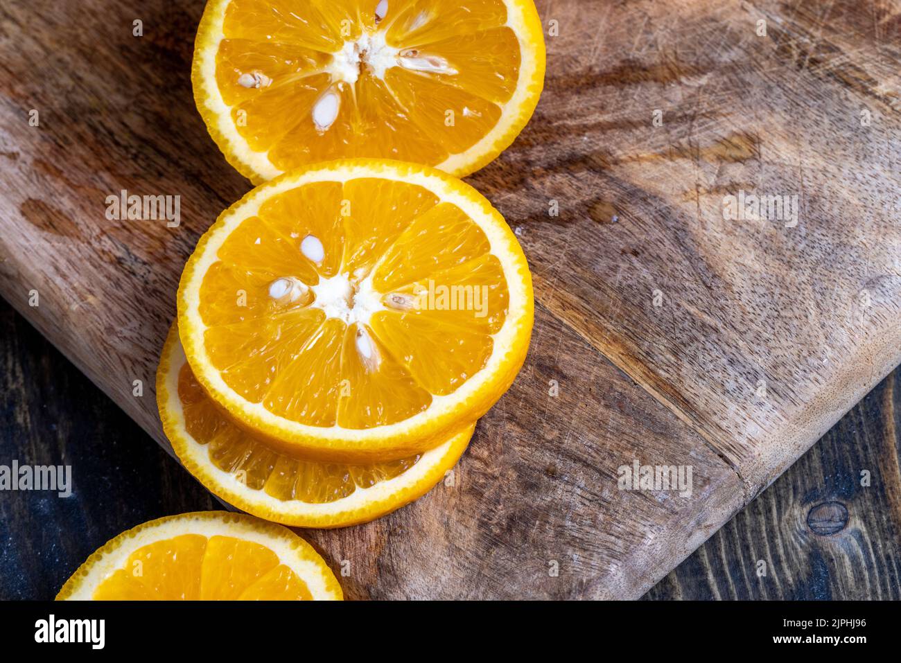 not peeled ripe orange cut into slices during cooking, ripe orange ...