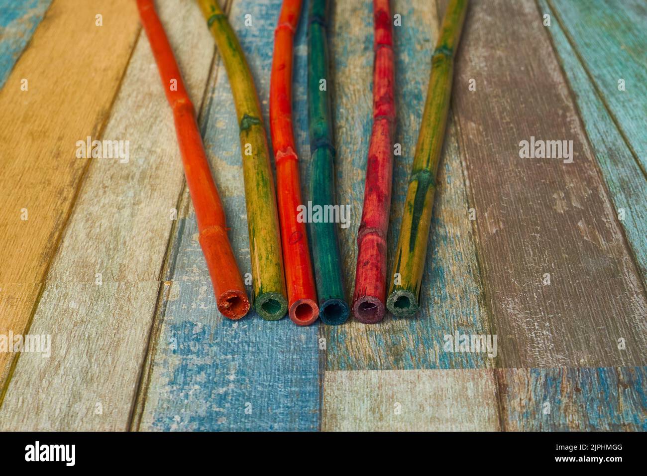 Several colorful Bamboo sticks on a wooden table Stock Photo - Alamy