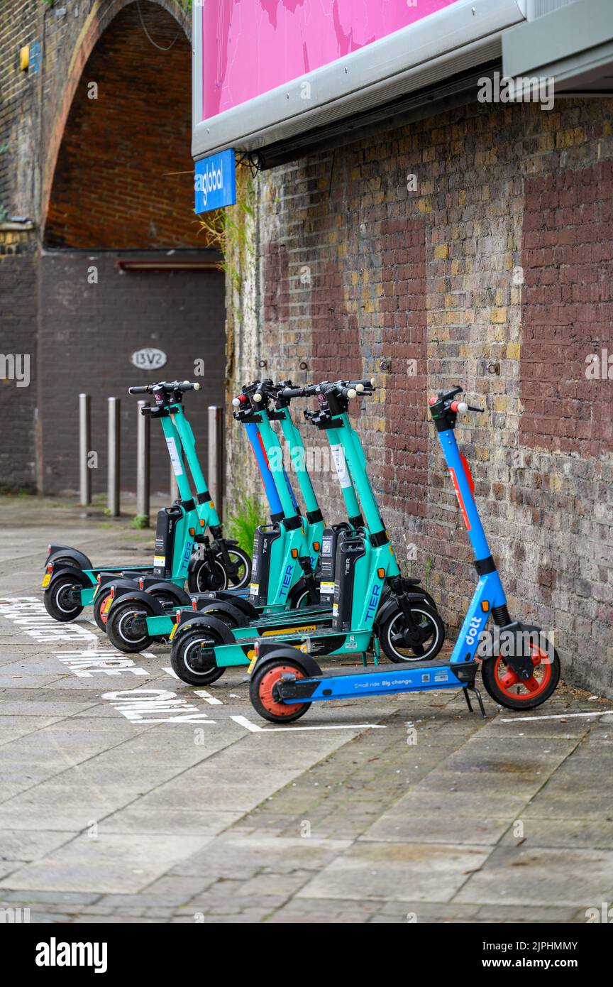 LONDON - May 20, 2022: Electric Rental Scooters lined up on pavement ...