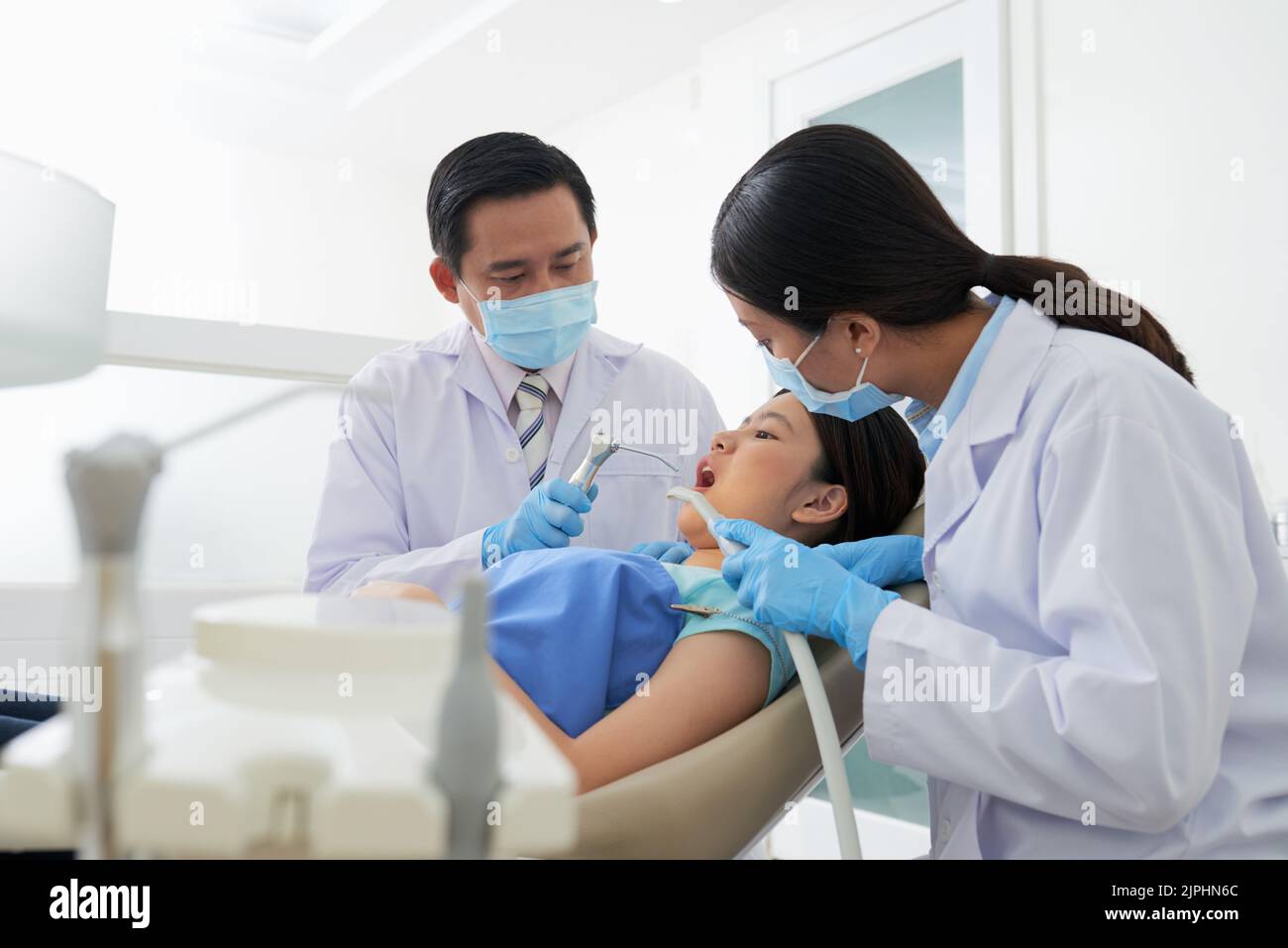Girl getting teeth filling done at dental clinic Stock Photo - Alamy