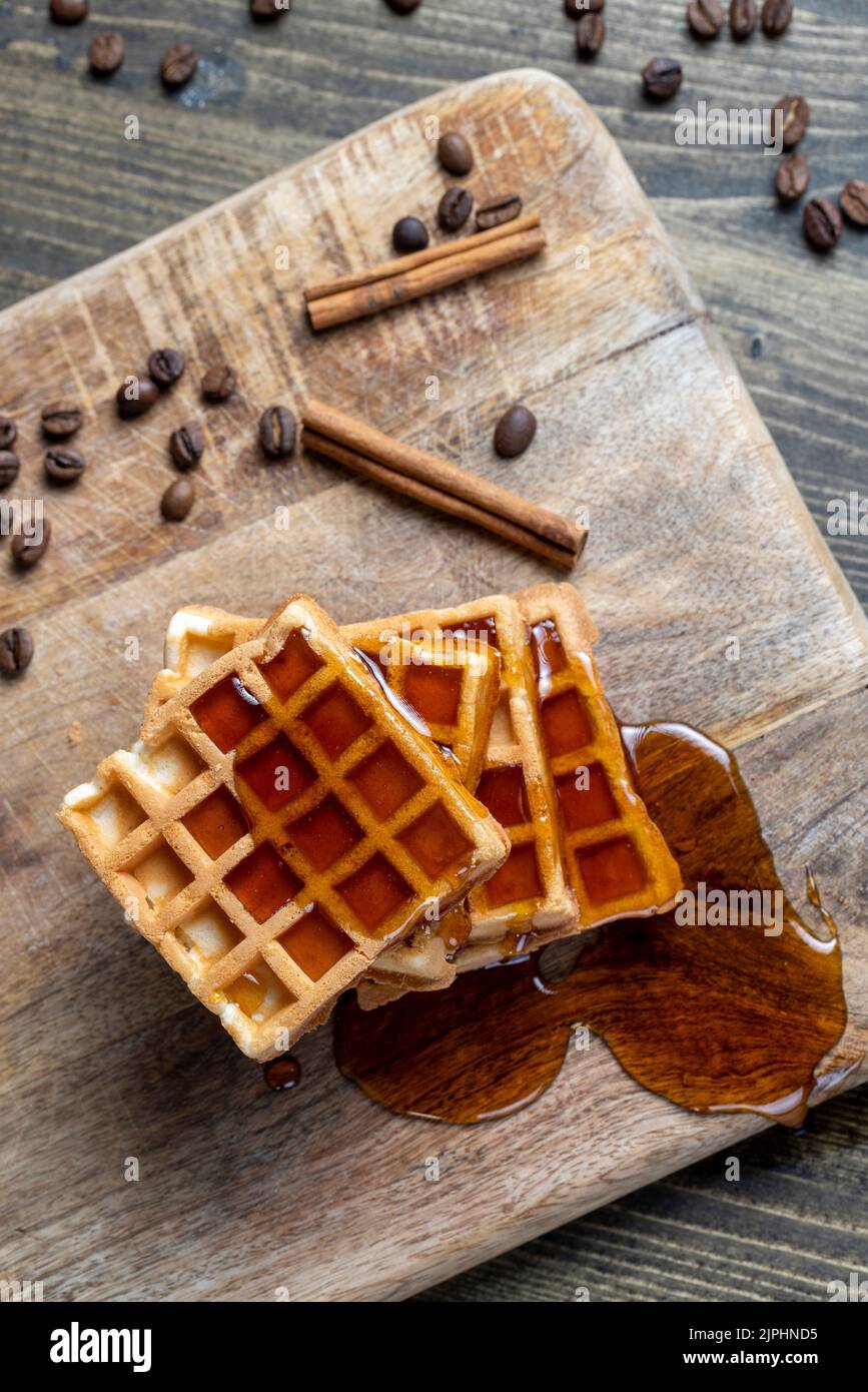soft waffles with natural bee honey on a serving board, cooking with ...
