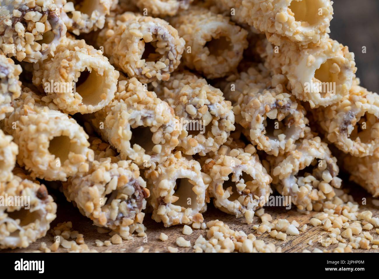 waffle tube with chocolate filling and crushed peanuts, sweet waffle ...