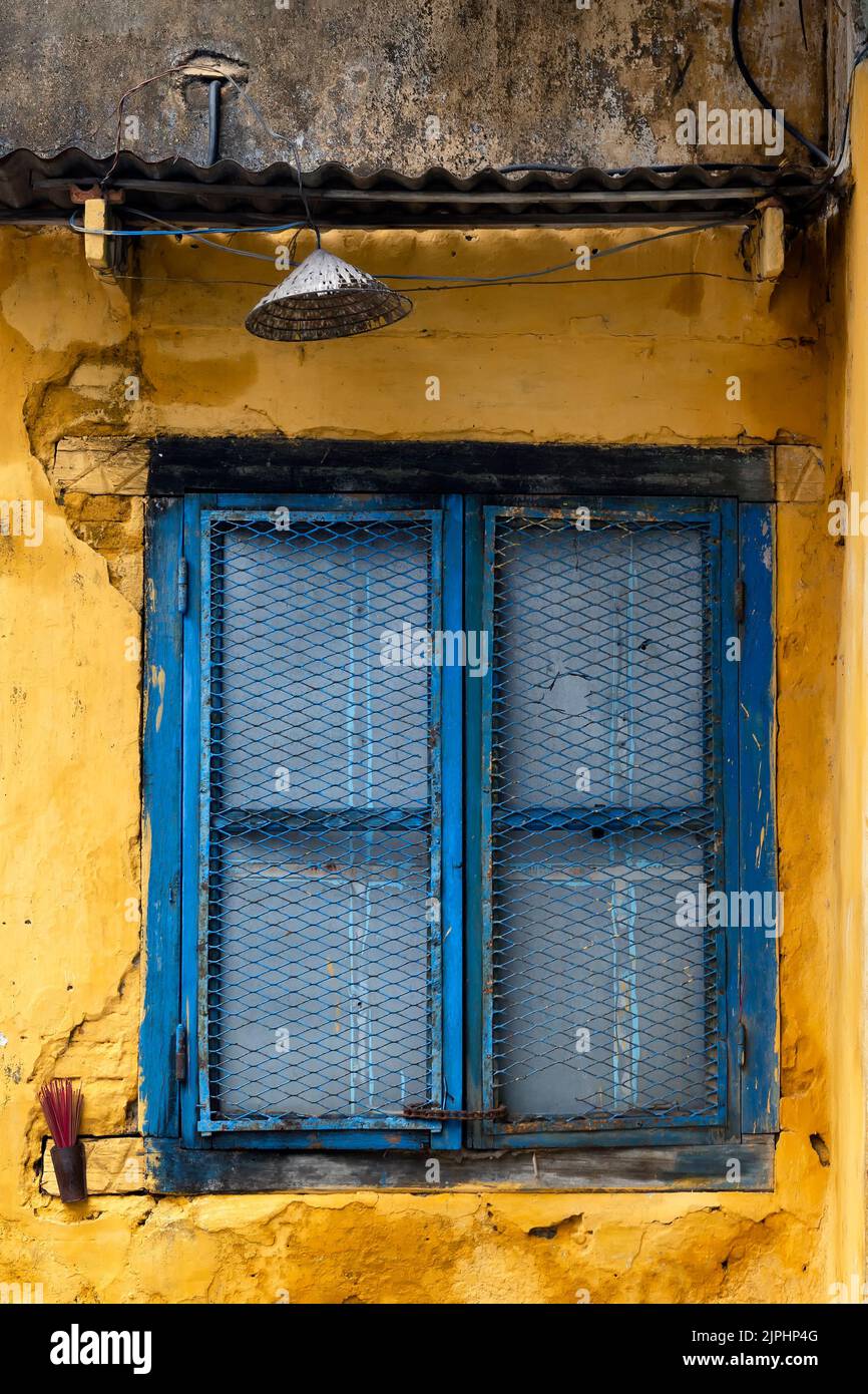 Old blue windows with incensticks on the left Stock Photo - Alamy