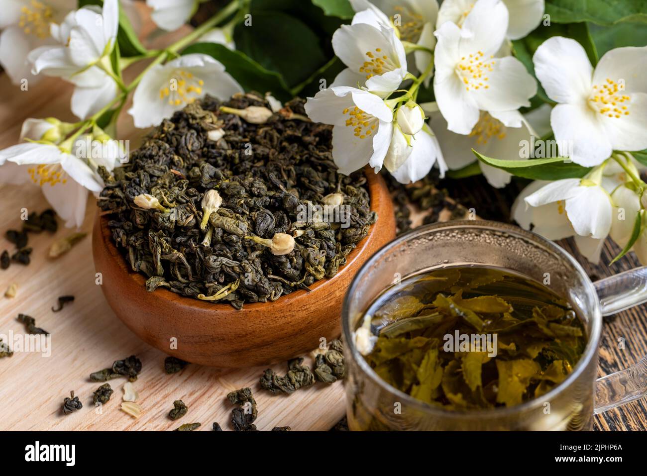 A real green hour with jasmine on the table, dried tea leaf for brewing ...