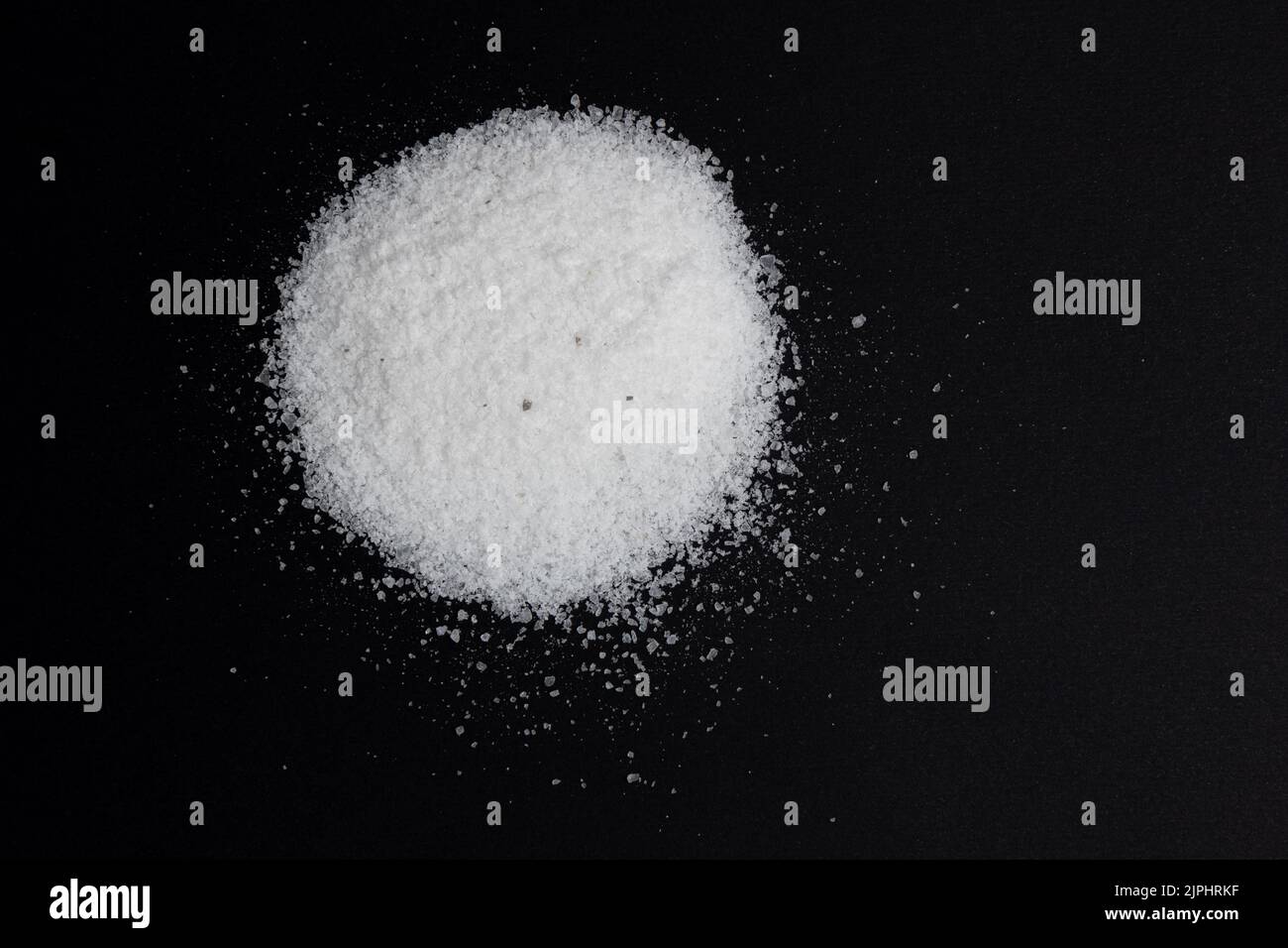 pile of kitchen salt, mineral sea salt isolated on black background ...