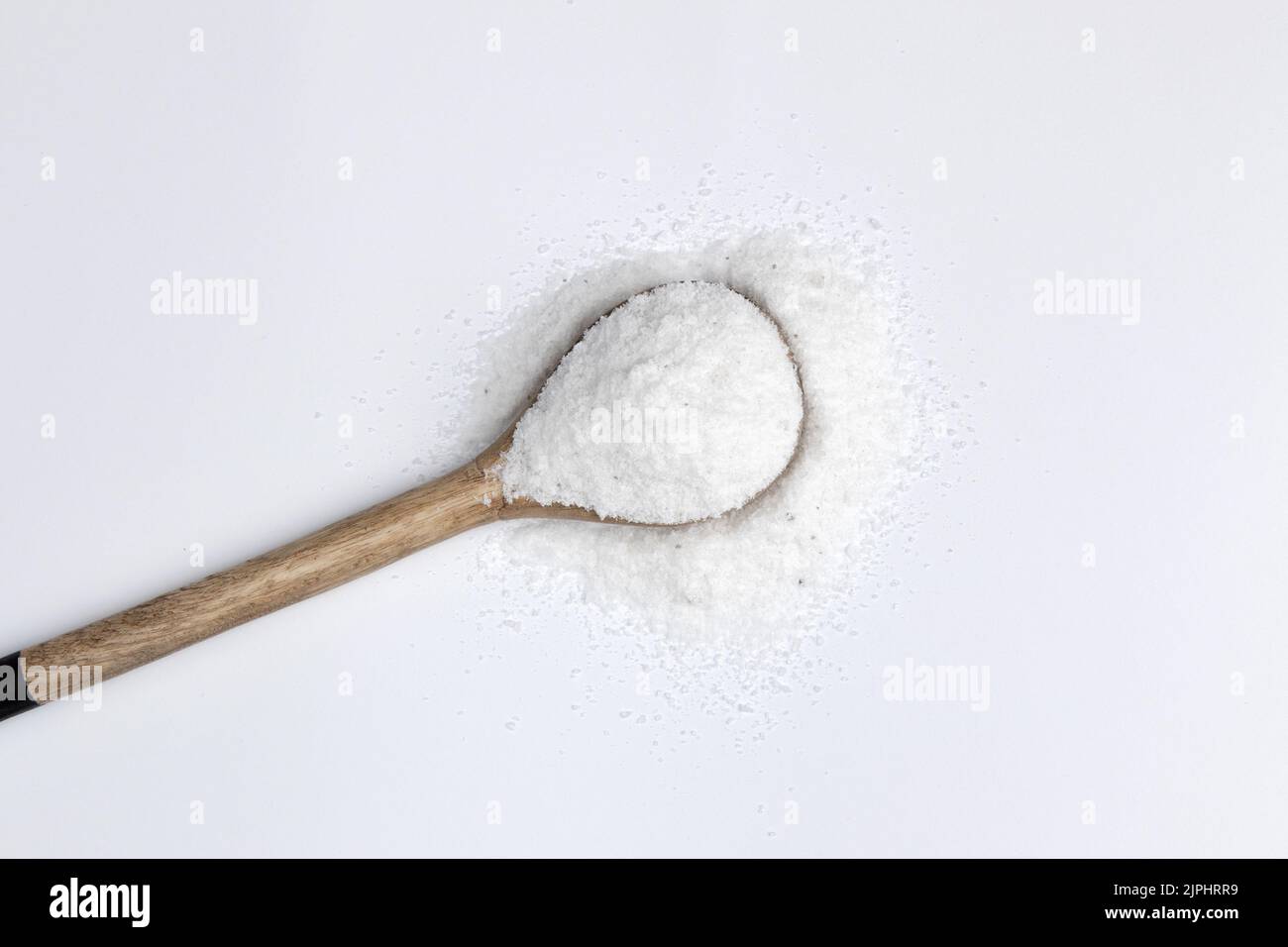 pile of kitchen salt, mineral sea salt in wooden spoon isolated on ...