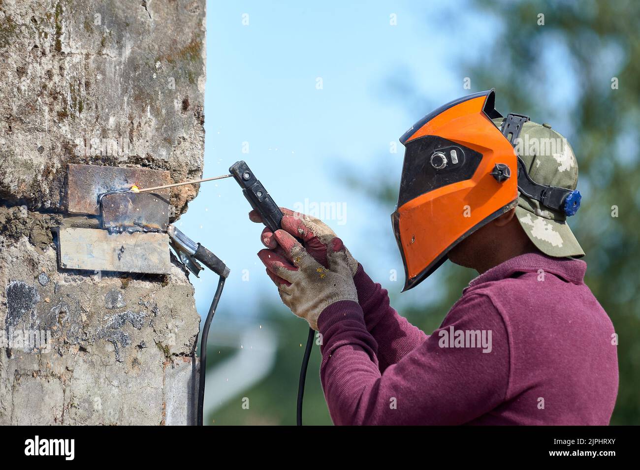 The welder welds reinforced concrete products together Stock Photo - Alamy