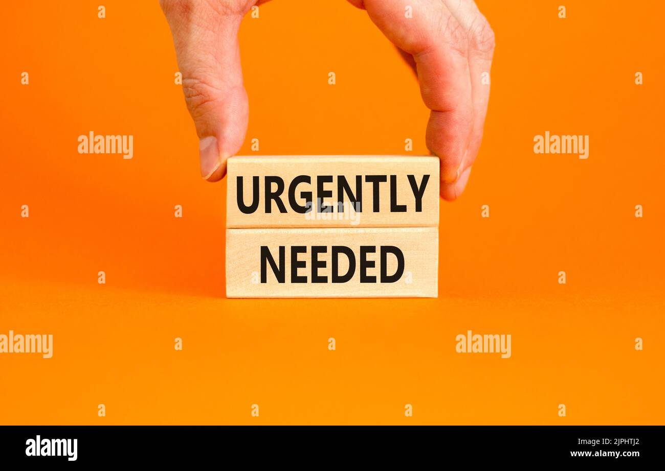 Urgently needed symbol. Concept words Urgently needed on wooden blocks ...