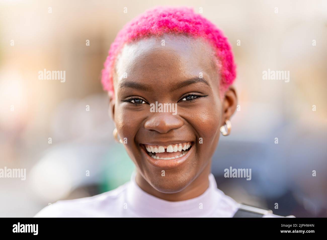 African woman with short pink hair smiling Stock Photo - Alamy