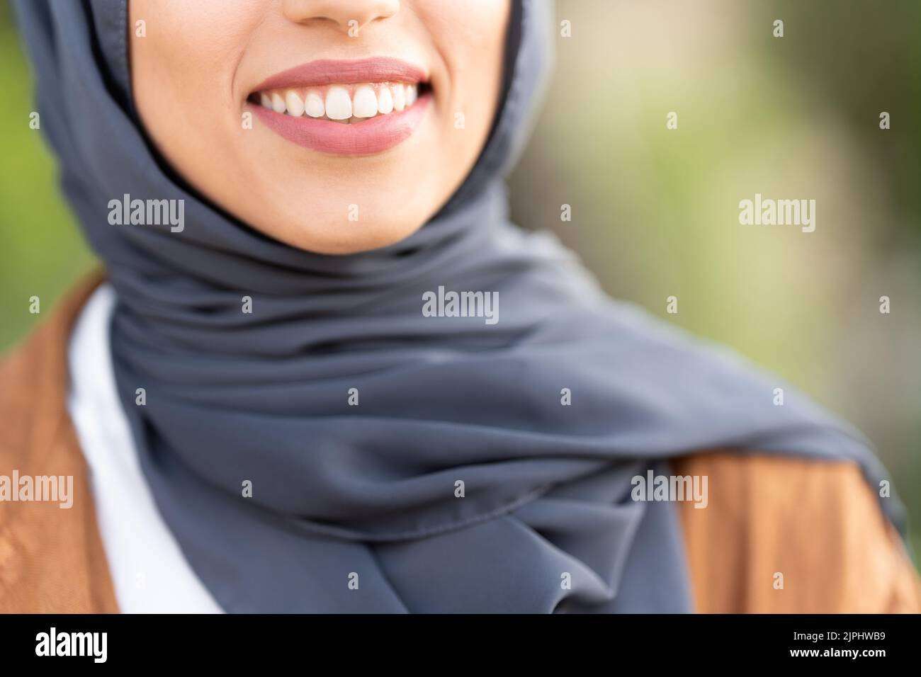 Cropped image of the smile of a muslim woman Stock Photo - Alamy