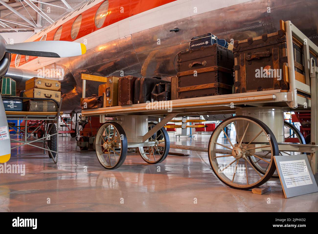 A closeup of old luggage on an aircraft trolley inside the aircraft ...