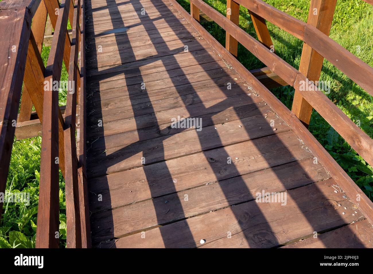 details of an old wooden bridge over a small river, part of a wooden ...