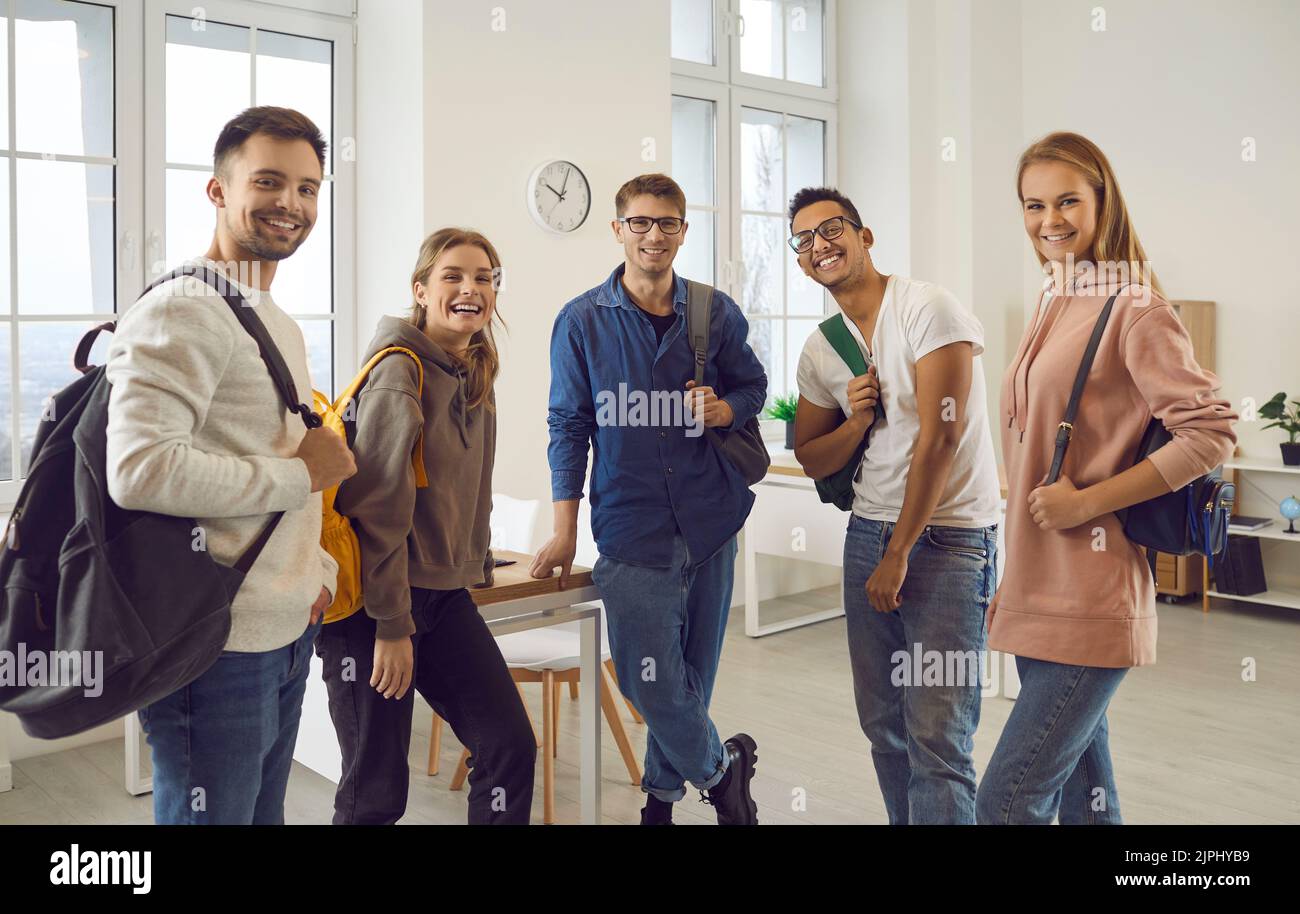 Portrait of diverse student pose with backpacks in classroom Stock ...