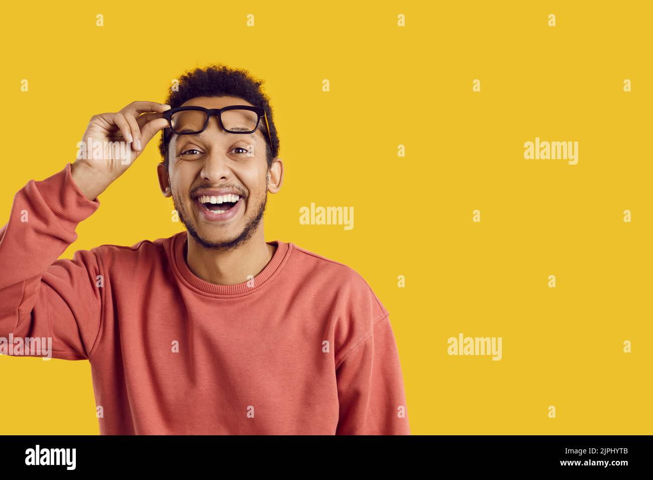 Happy black university student laughing and looking at camera isolated ...