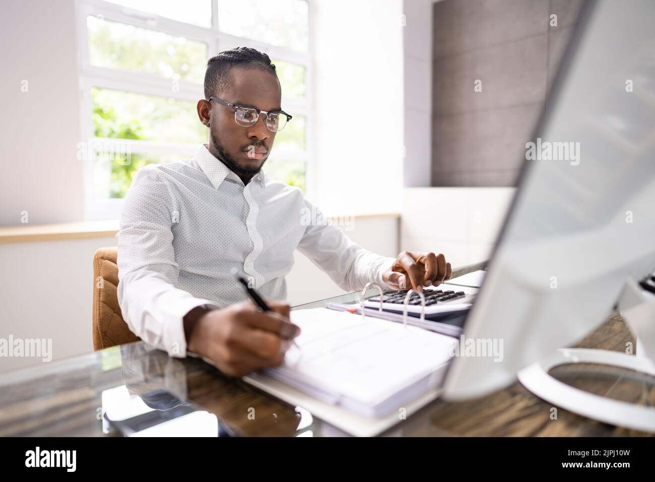 African American Accountant Or Auditor With Calculator Stock Photo - Alamy