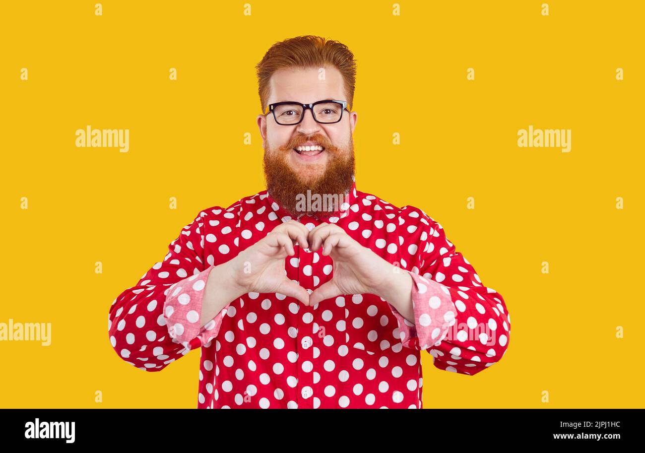 Portrait of cheerful funny bearded fat man showing love gesture ...