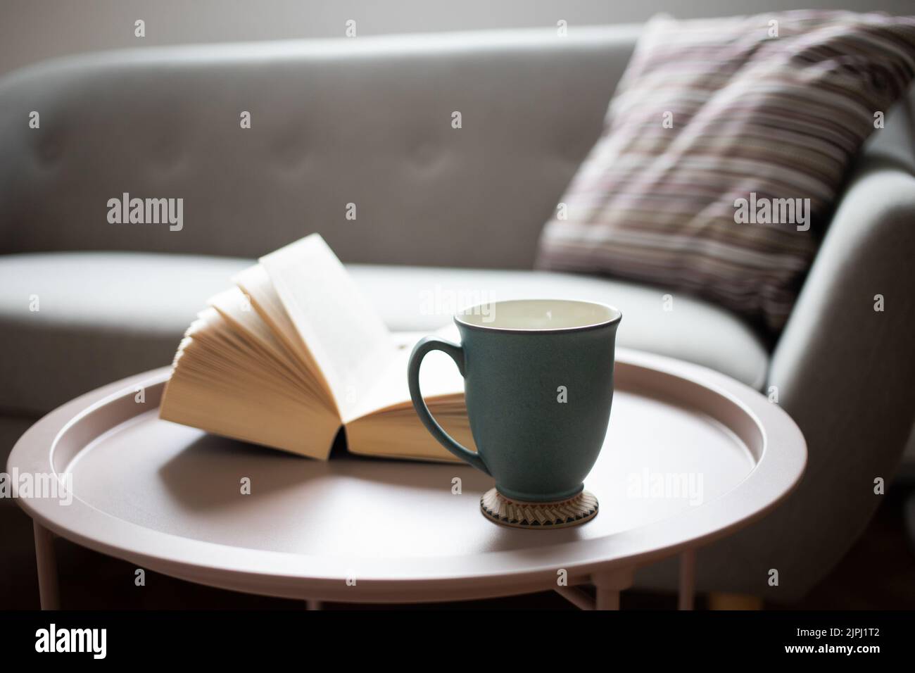 open book on a living room table Stock Photo - Alamy