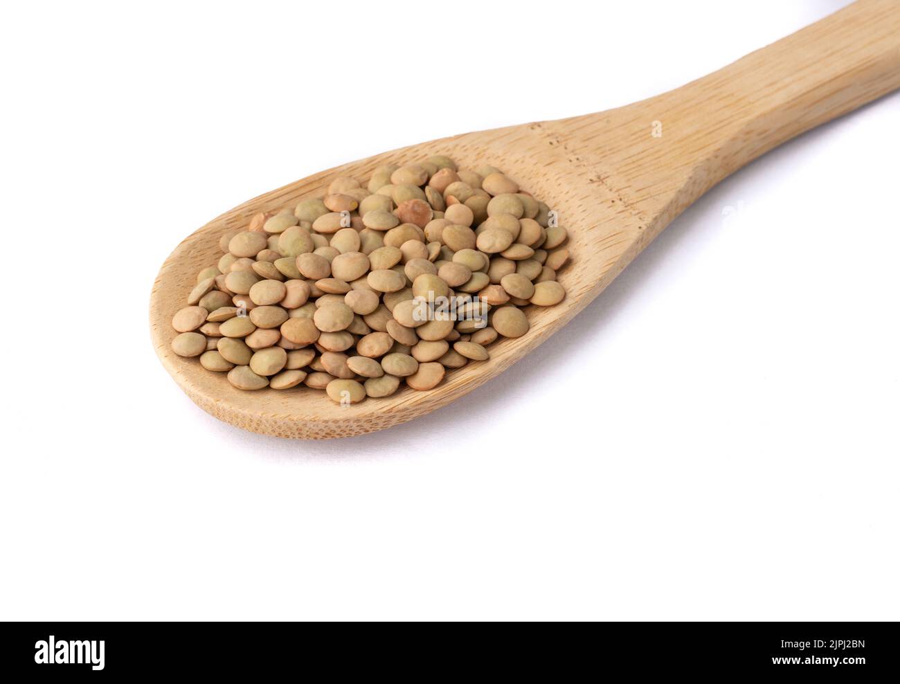 Raw lentils on a spoon isolated over white background Stock Photo - Alamy