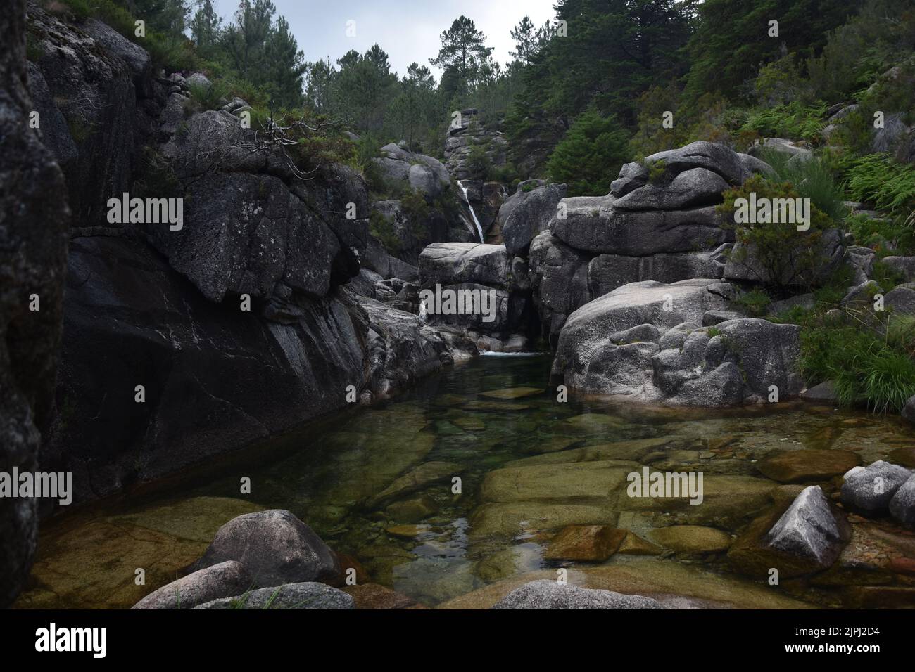 A small waterfall and mountain lake in nature Stock Photo - Alamy