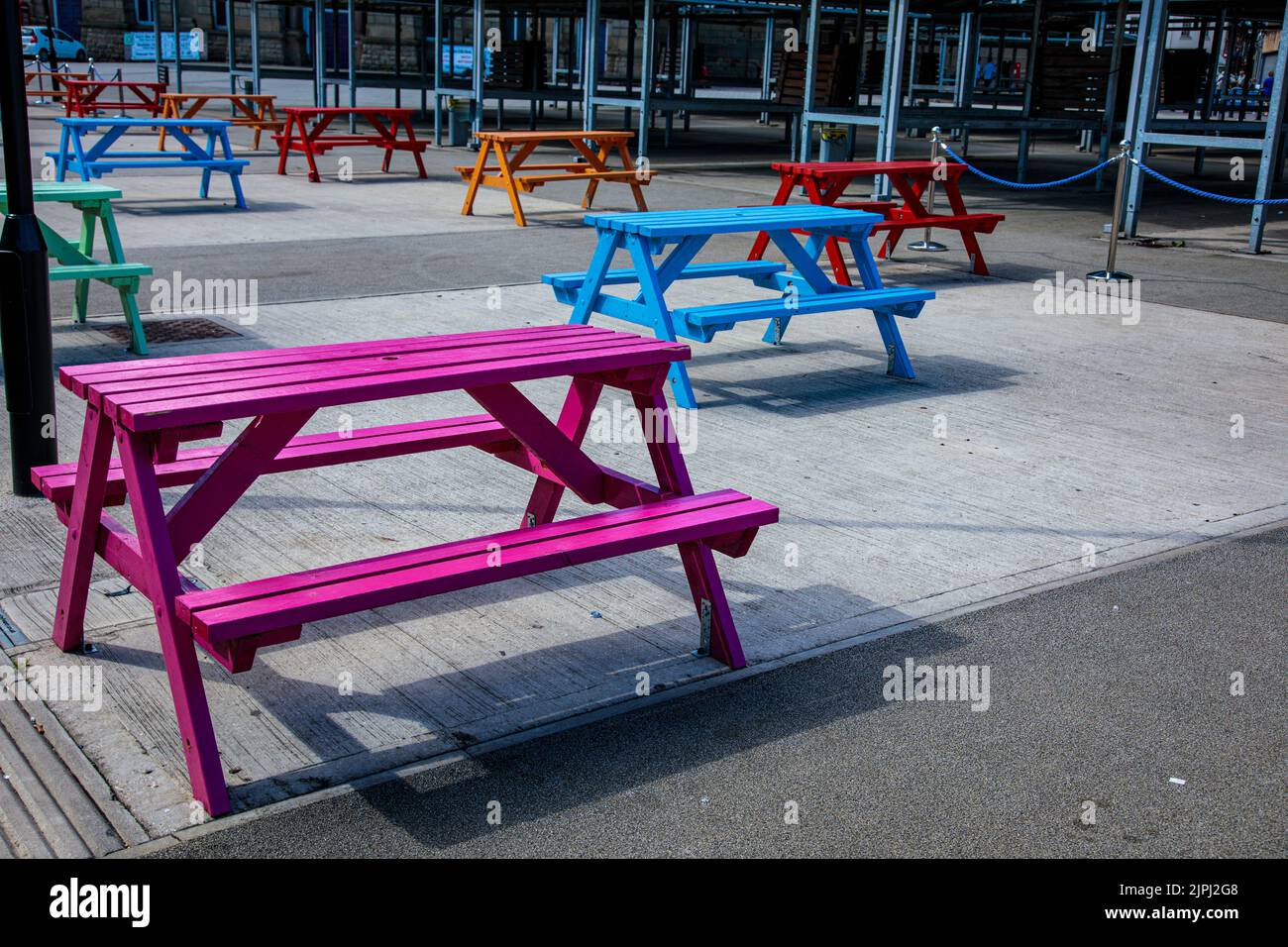 Colourful picnic benches in a Market Square on a sunny day Stock Photo - Alamy
