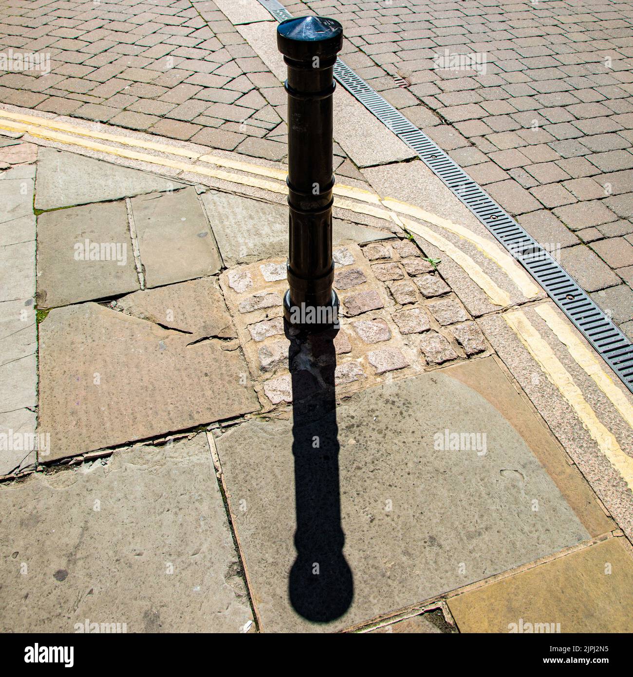 No parking post on hot sunny day with Longshadow Stock Photo - Alamy