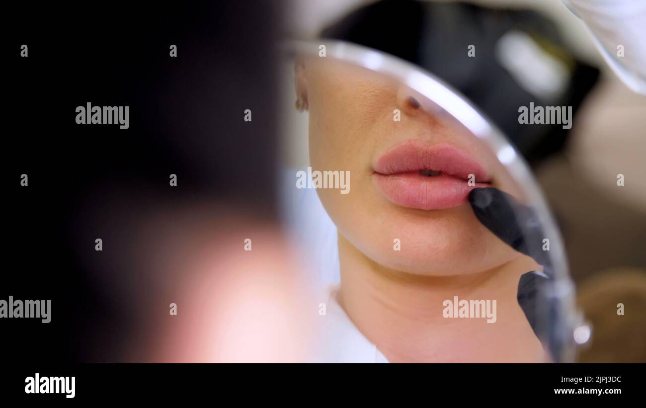 medical office, beautiful woman looking in the mirror, doctor probes ...